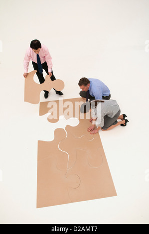 Group of business people assembling jigsaw puzzle and represent team ...