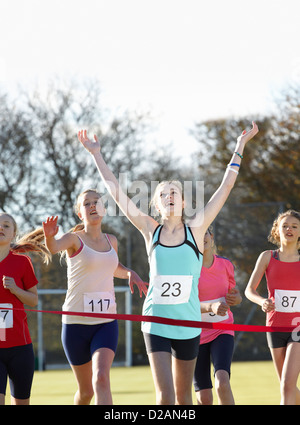 Runner crossing race finish line Stock Photo - Alamy