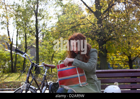 Woman rummaging through purse Stock Photo - Alamy