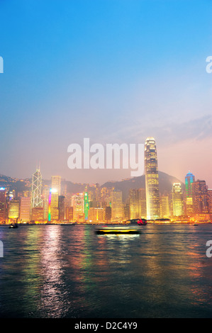 Hong Kong Victoria Harbor morning with urban skyscrapers over sea lit ...