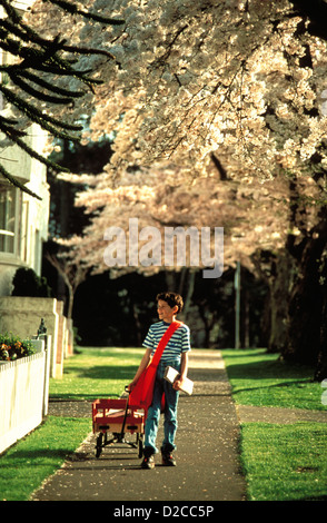 Boy delivering newspaper Stock Photo - Alamy