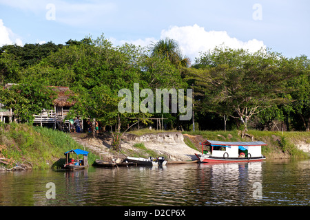 Riverside village along the Amazon River with traditional wooden houses ...