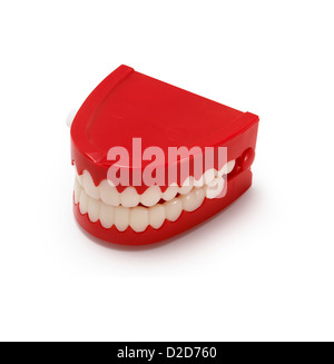 Plastic tooth with brush and chewing gums on light yellow background ...