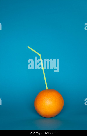 Orange with Straw stuck in it Stock Photo - Alamy