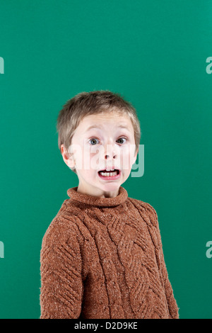 Shocked kid boy on studio isolated background. Surprised face, excited ...