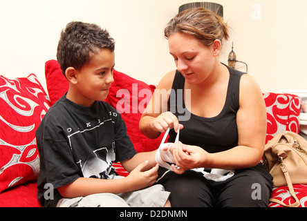 A mother doing first aid on her son Stock Photo - Alamy