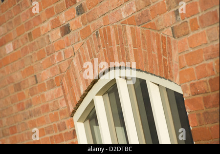 Arched brickwork over a window on a newly renovated barn in rural ...