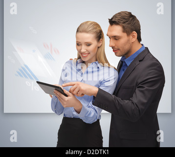 Happy young businessman with tablet and his pretty colleague consulting ...