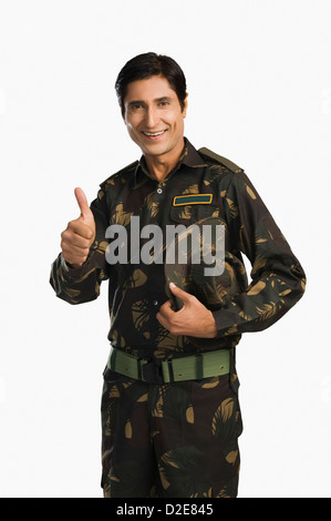 Army soldier showing thumbs up sign with credit card Stock Photo - Alamy