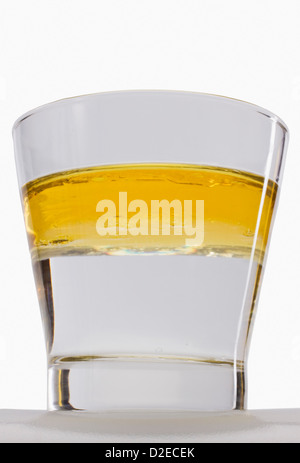 Oil floating on water surface in a glass Stock Photo - Alamy