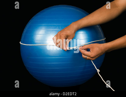 Close-up of a man measuring a curved surface with a string Stock Photo ...