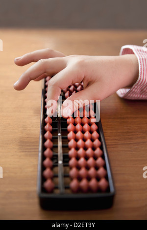 Child's hand using a Japanese abacus (soroban) also known as counting ...