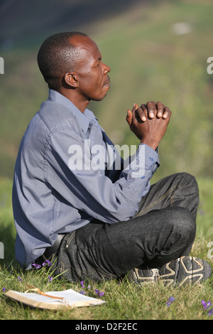 Man praying outside Stock Photo - Alamy