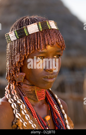 Portrait of lovely Hamar woman with ocre in hair and beautiful beaded ...