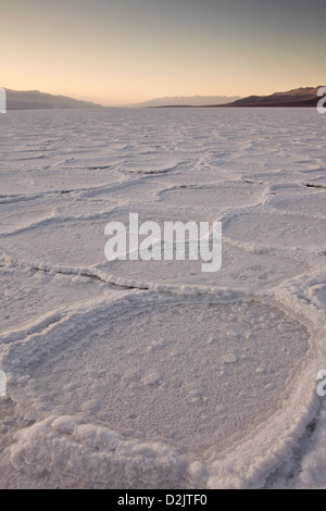 Salt pan polygons below the Black Mountains at Badwater during sunset ...