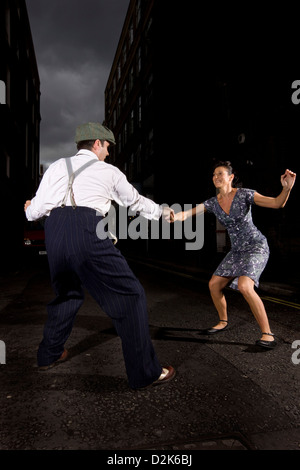 Couple dancing in front of their car. Man and woman enjoying a summer ...