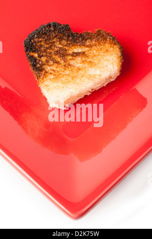 Toast with heart-shaped set in white plate Stock Photo - Alamy