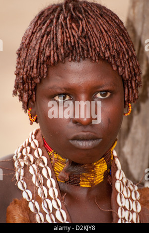 Portrait of lovely Hamar woman with ocre in hair and beautiful beaded ...