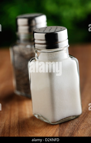 Salt and Pepper shaker on a wooden table Stock Photo - Alamy