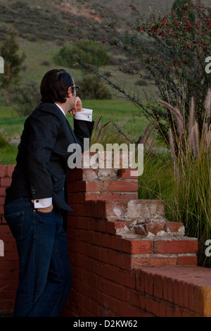 Man looking over a wall Stock Photo - Alamy