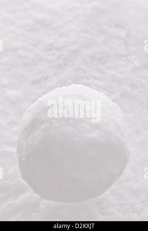 One single snowball on a snow background Stock Photo - Alamy