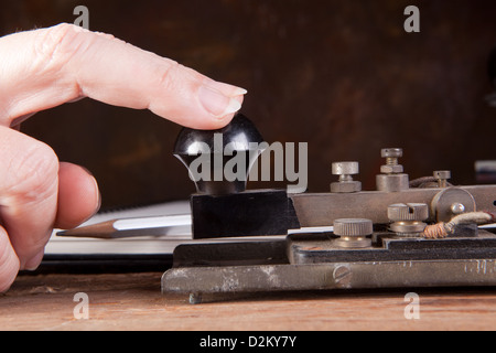 Hand tapping morse code on an antique telegraph Stock Photo - Alamy