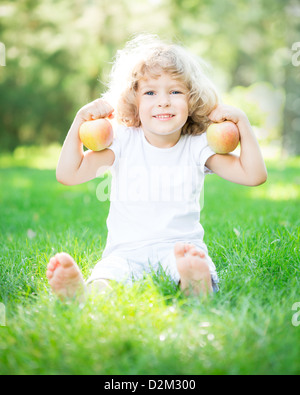 Child playing with apples in spring Stock Photo - Alamy