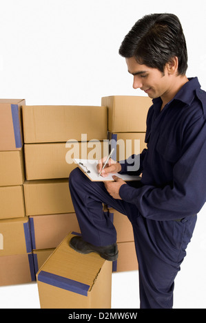 Store incharge counting cardboard boxes Stock Photo - Alamy