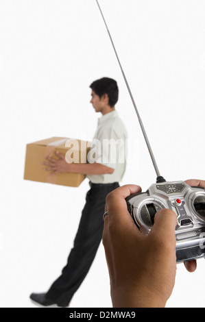 Person's hands controlling a worker with a remote control Stock Photo ...