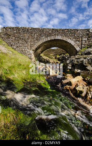Stone bridge over fast flowing river Stock Photo - Alamy