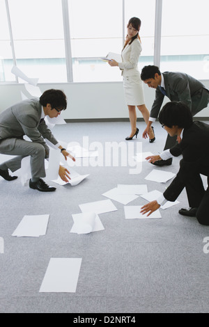 young woman picking up papers dropped in the street Stock Photo - Alamy