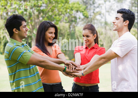 Joining hands together outdoors, friends showing unity and teamwork ...