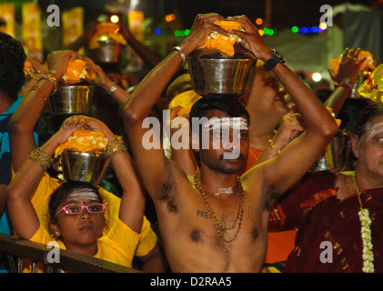 Family carrying pots at the Thaipusam Hindu festival at Malaysia's Batu ...