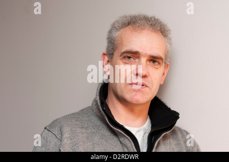 Middle age man with grey hair standing over yellow background smiling ...