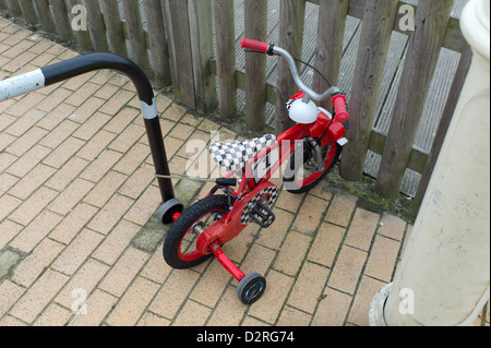 Red kid's bike chained to a bike rail, Poland, Europe, EU Stock Photo ...