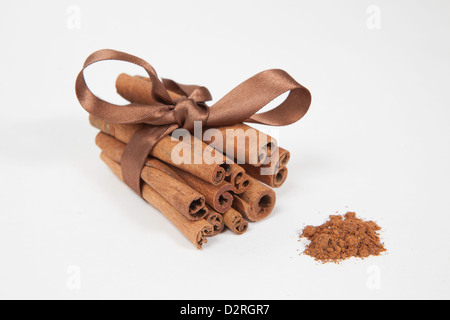 Set with aromatic cinnamon sticks and powder on white background Stock ...