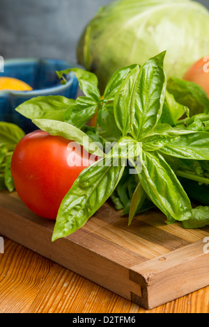 Sprig of fresh green basil leaves with dried hot spicy cayenne chili ...