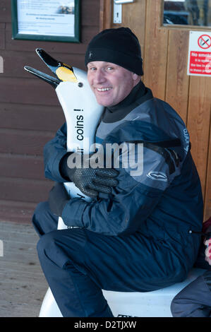 TV presenter Mike Dilger dons a dry suit to feed swans and wildfowl at ...