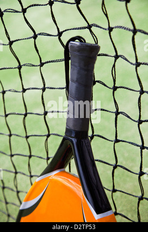 Hand holding paddle or padel tennis racket on white background ...