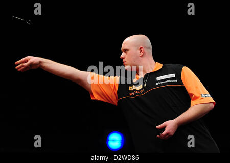 Michael van Gerwen of the Netherlands throws his dart during the final ...