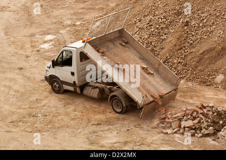 Small tipper truck dumping a load of bricks and rubble Stock Photo - Alamy