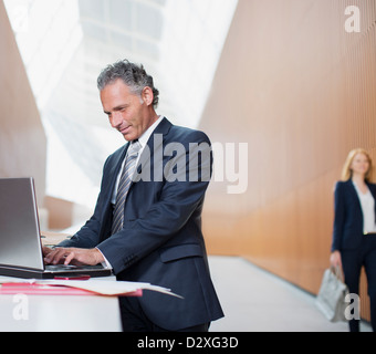 Business man using laptop in black suit with panoramic city view ...
