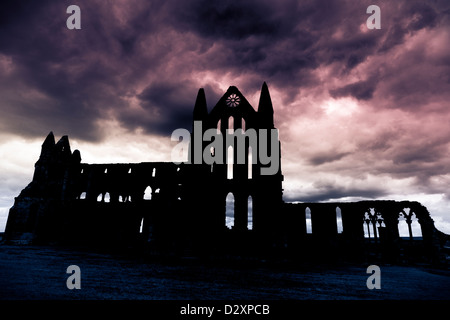 Silhouette of Whitby Abbey, Yorkshire, England, lit by the evening ...