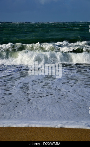 Breaking waves, swash and backwash over shingle on the beach at ...