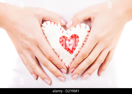A woman holds a small red object up to her face Stock Photo - Alamy