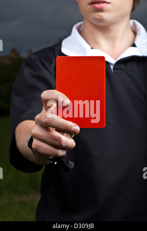 Referee holding red card football Stock Photo - Alamy