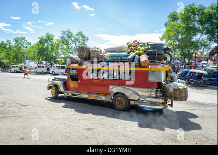 Overloaded jeepney starting the journey at Puerto Princesa bus station ...