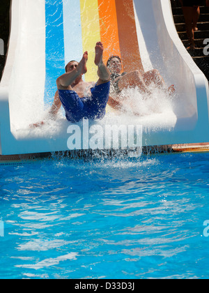 Tourists enjoy waterslides at Caliente Bodrum Resort Hotel. Torba ...