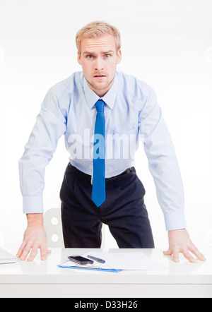 serious boss sitting behind desk at office looking at camera Stock ...