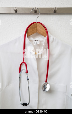 Lab coat and stethoscope hanging on a coat rack Stock Photo - Alamy